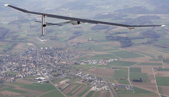 Solar plane soars, slowly, on first flight