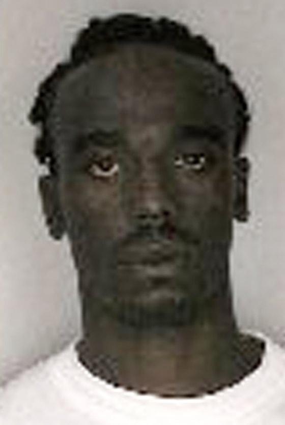 At-large suspect in cop killings has prison past