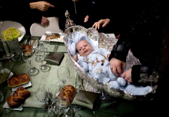 A first born son receives ancient Jewish ritual