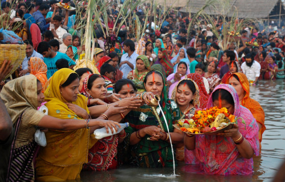 Hindus worship the sun god as night falls during Chhath Puja
