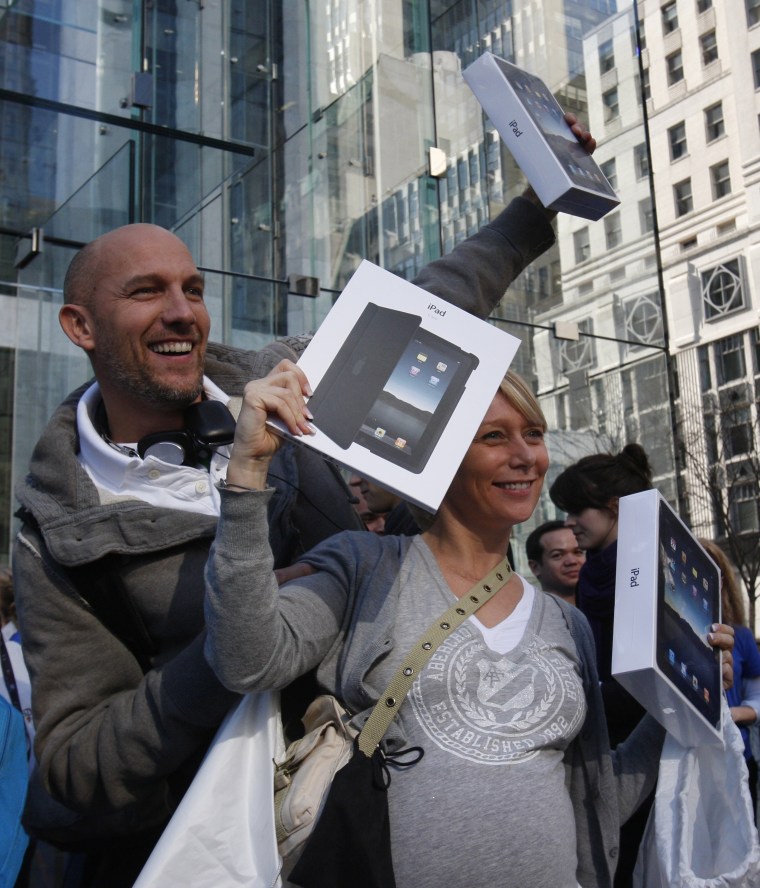 iPad fans eagerly touch and swipe away