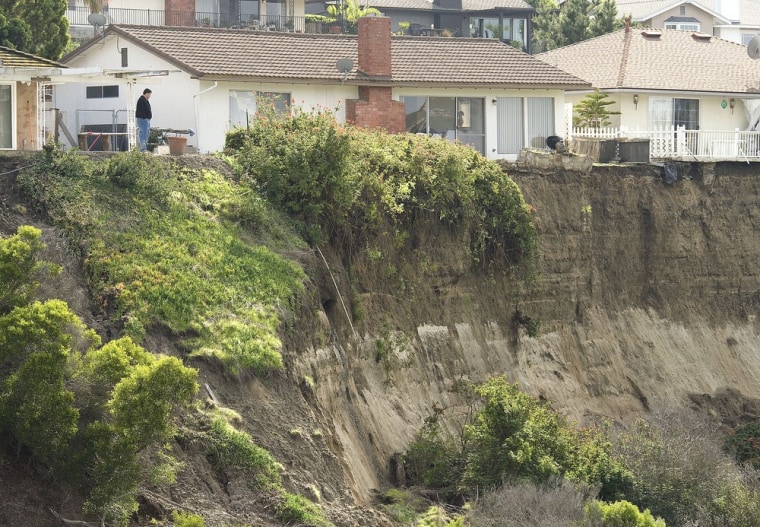 Hillside collapse leaves houses on the brink of vertical drop