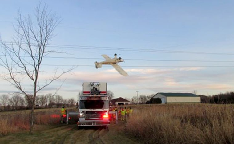 Photos show plane precariously dangling upside down from power lines in ...