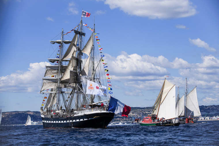 A ship carrying the Olympic torch arrives in Marseille amid fanfare and ...