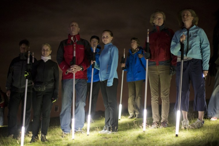 Runners, walkers illuminate Edinburgh hillside in festival performance