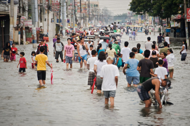 Waiting, wading and mourning in flood-stricken Philippines, as death ...