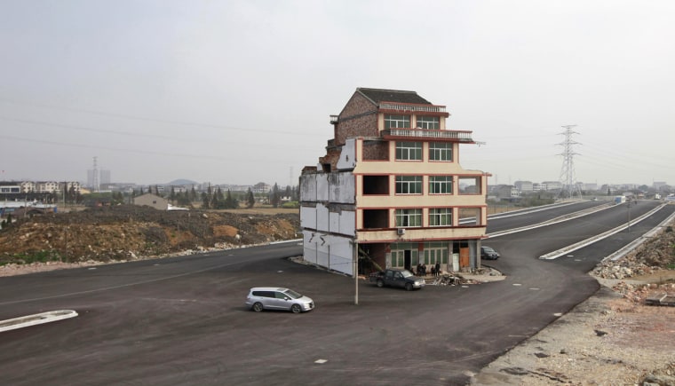 China tears down house in middle of highway after owner agrees to ...