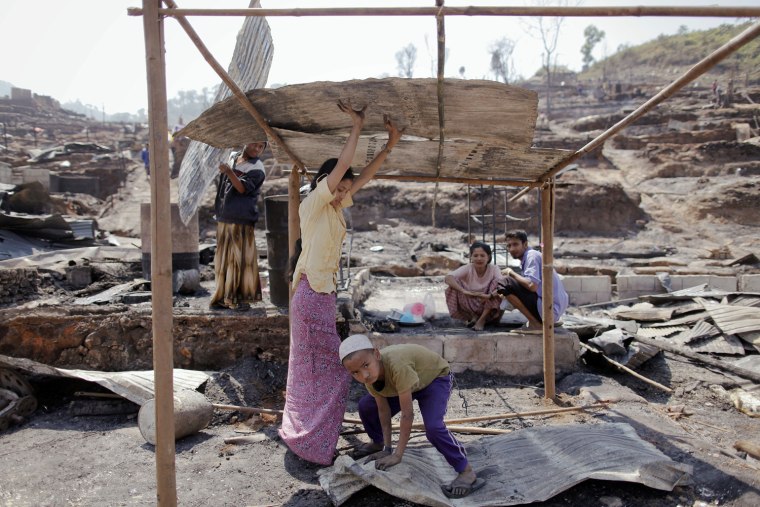 Among the charred ruins of a refugee camp, a smile remains