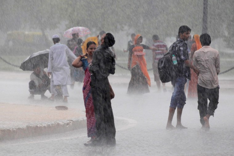 Indians enjoy heavy rain shower in New Delhi