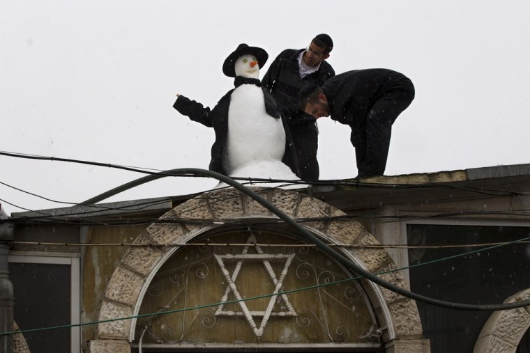 Israelis and Palestinians alike revel in snow blanketing the Holy Land