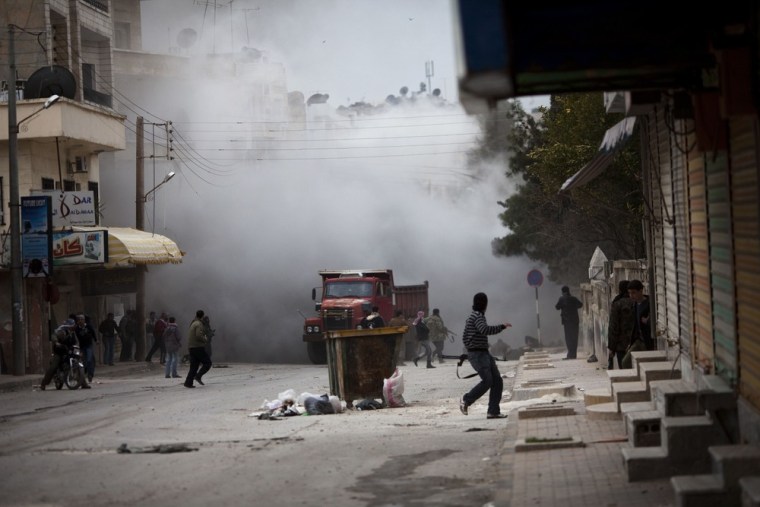Free Syrian Army fighters plant a roadside bomb to strike a tank