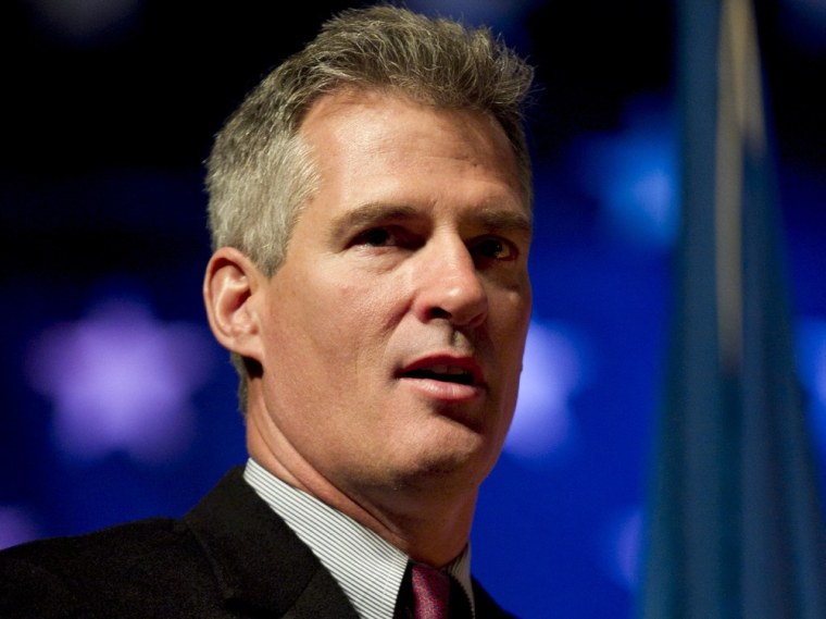 Scott Brown cites pride in 'standing with President Obama' in ad