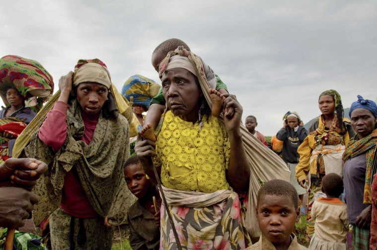 Displaced villagers march with their belongings to escape Congo fighting