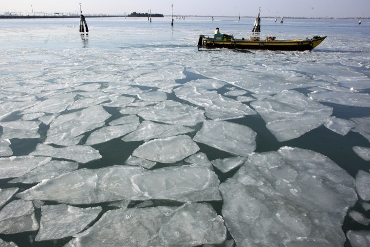 Ice clogs the canals of Venice, Italy
