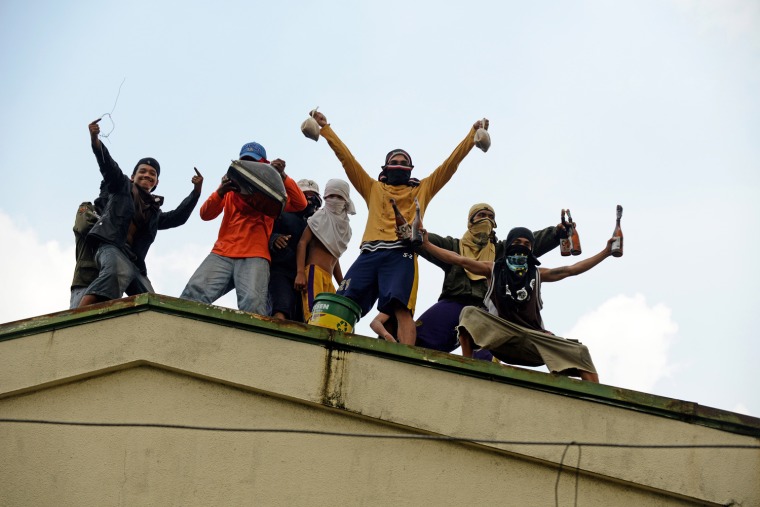 Armed with rocks and bottles, squatters clash with police as homes are ...