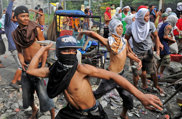 Armed with rocks and bottles, squatters clash with police as homes are ...