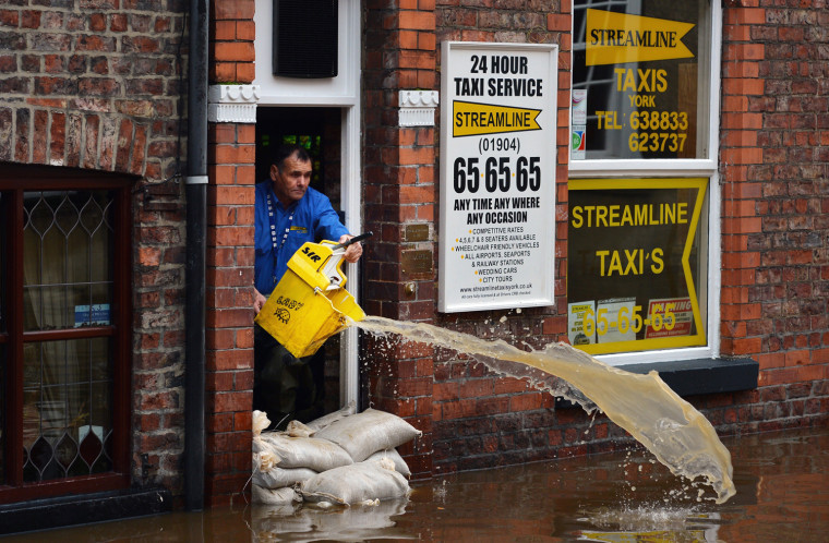 Keep calm and drink beer? Brits carry on in rising flood waters