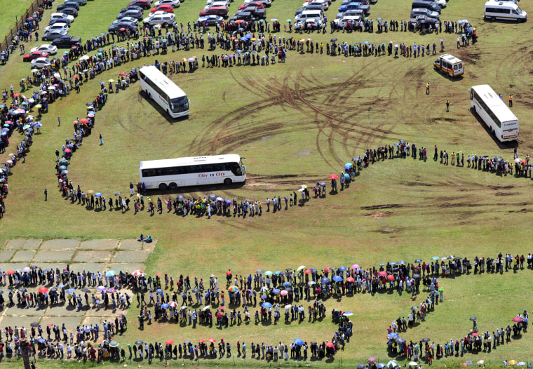 Snaking lines of Mandela mourners recall iconic images of voters in 1994
