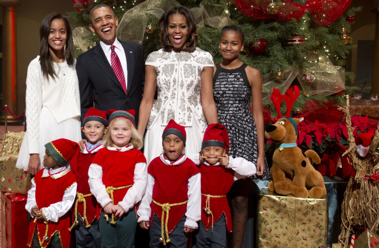 Cheeky elf's pose upstages first family's Christmas photo