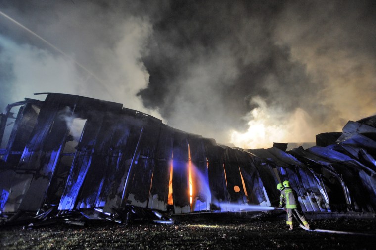 Burning paper mill leaves eerie, smoky scene in its wake