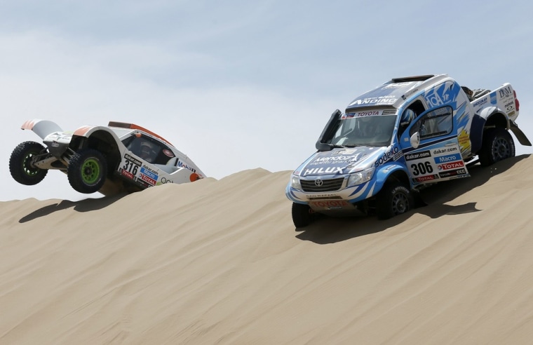 Competitors get stuck in, and escape, the sand dunes on Stage 6 of the ...