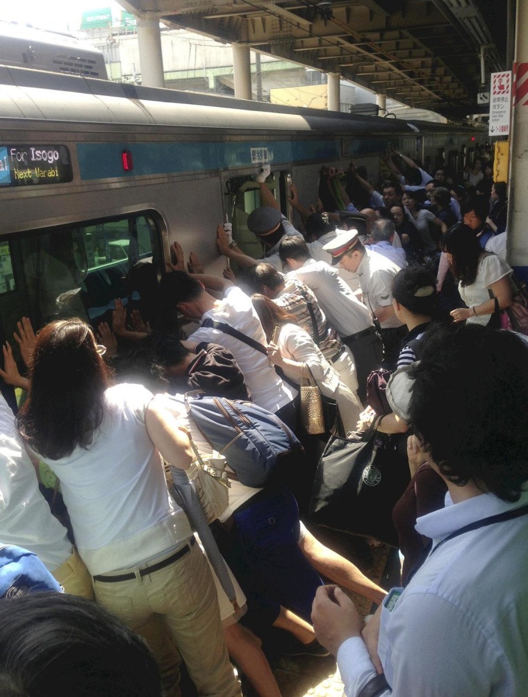Commuters become heroes when they work together to free woman trapped ...
