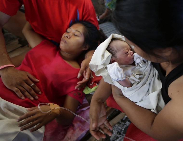 Miracle baby: Girl born at airport after pregnant typhoon victim swims ...