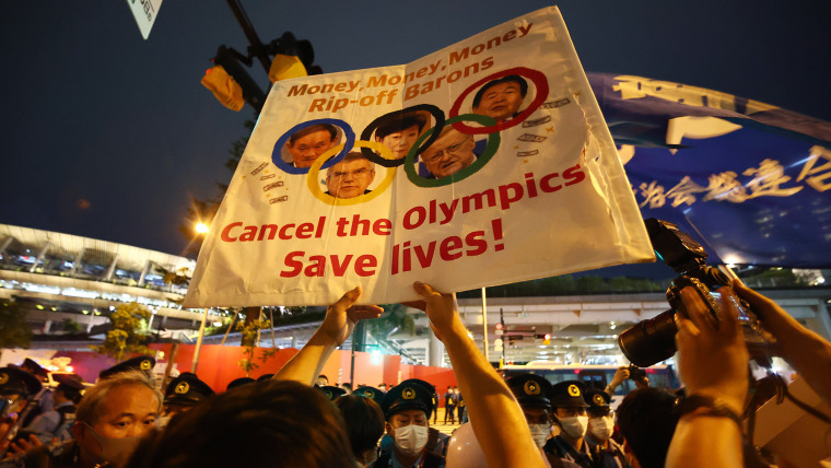 Anti-Olympic protesters march in Tokyo as opening ceremony begins
