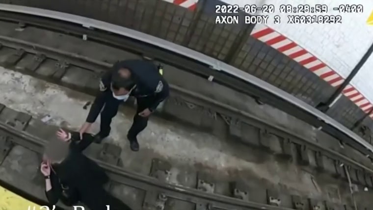 NYPD officer jumps onto subway tracks to save woman having seizure