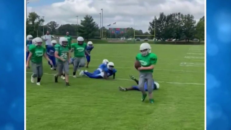Elementary school football teams come together to set up special play ...