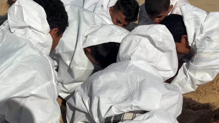 Kids in Gaza wear coronavirus suits to protect from cold and wet