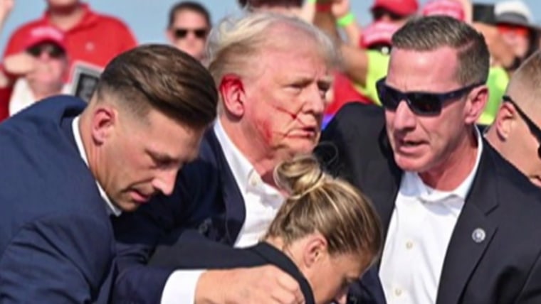 Photographer at rally says bullet took out piece of Trump's ear