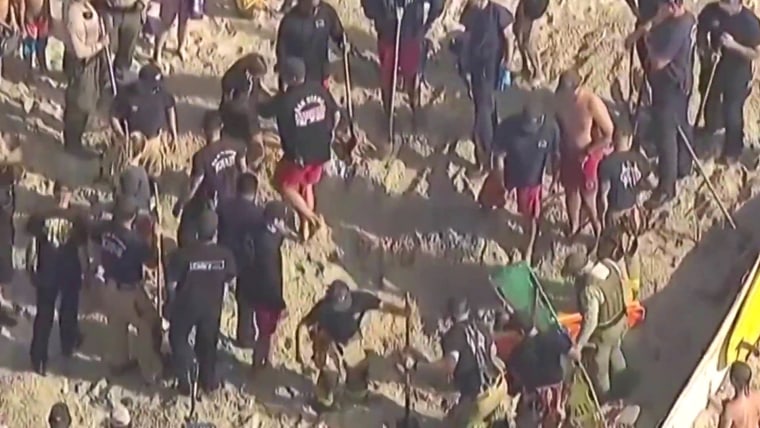 Watch officials rescue teen trapped 7-feet deep in the sand