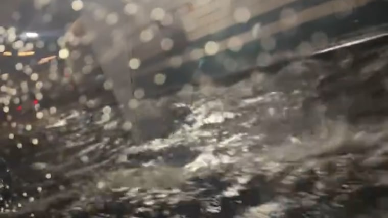 Cars drive through rain-flooded Boston tunnel