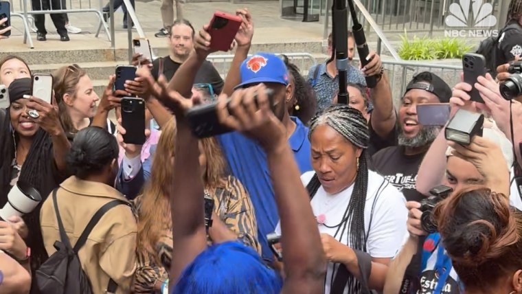 Diddy supporters dance with baby oil outside court