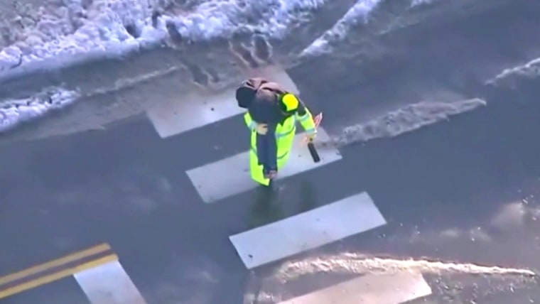 Crossing Guard Carries Student Across Flooded Chicago Street