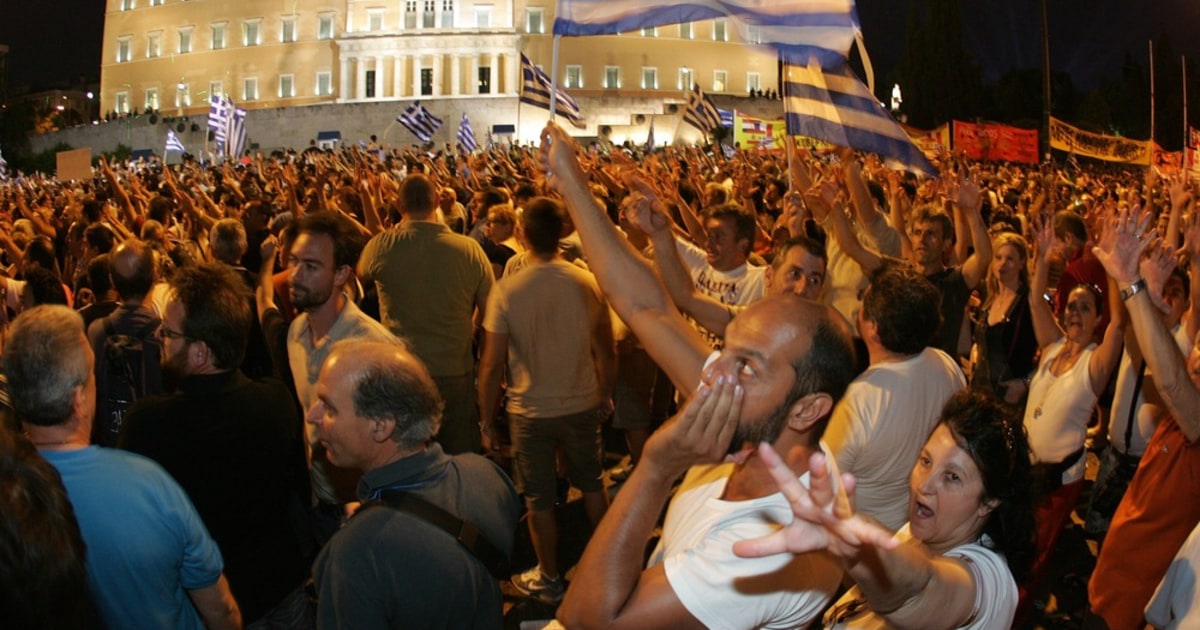 Greek leader survives crucial vote on debt crisis