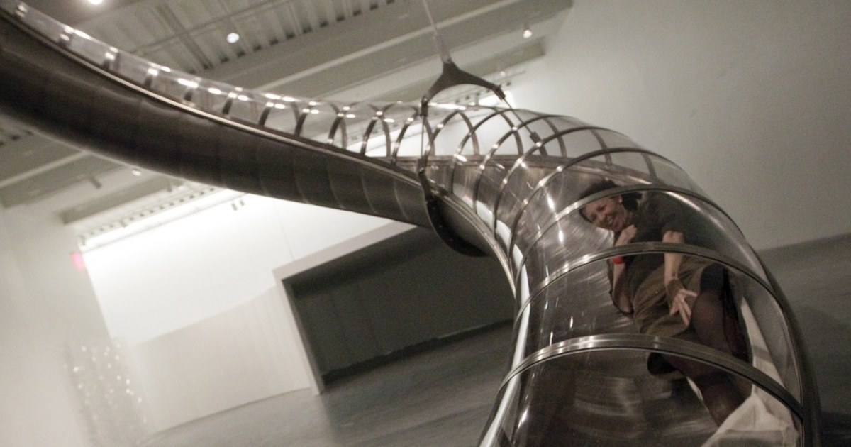 Visitors ride 3-story slide at NYC museum