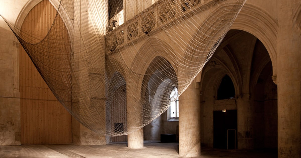 300 hanging wires form a buzzing, wiggling inverse arch