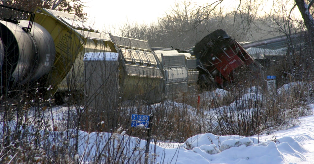 Freight trains collide; rail cars plunge into river