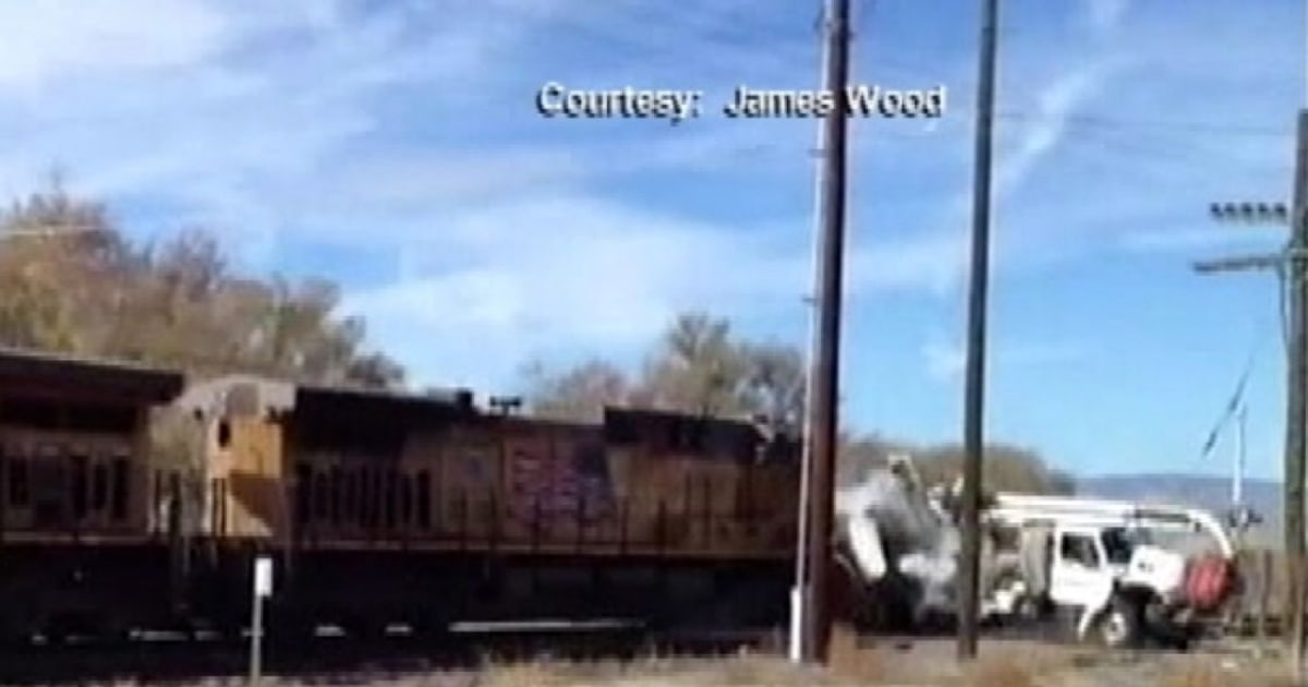 Camera captures train smashing into utility truck