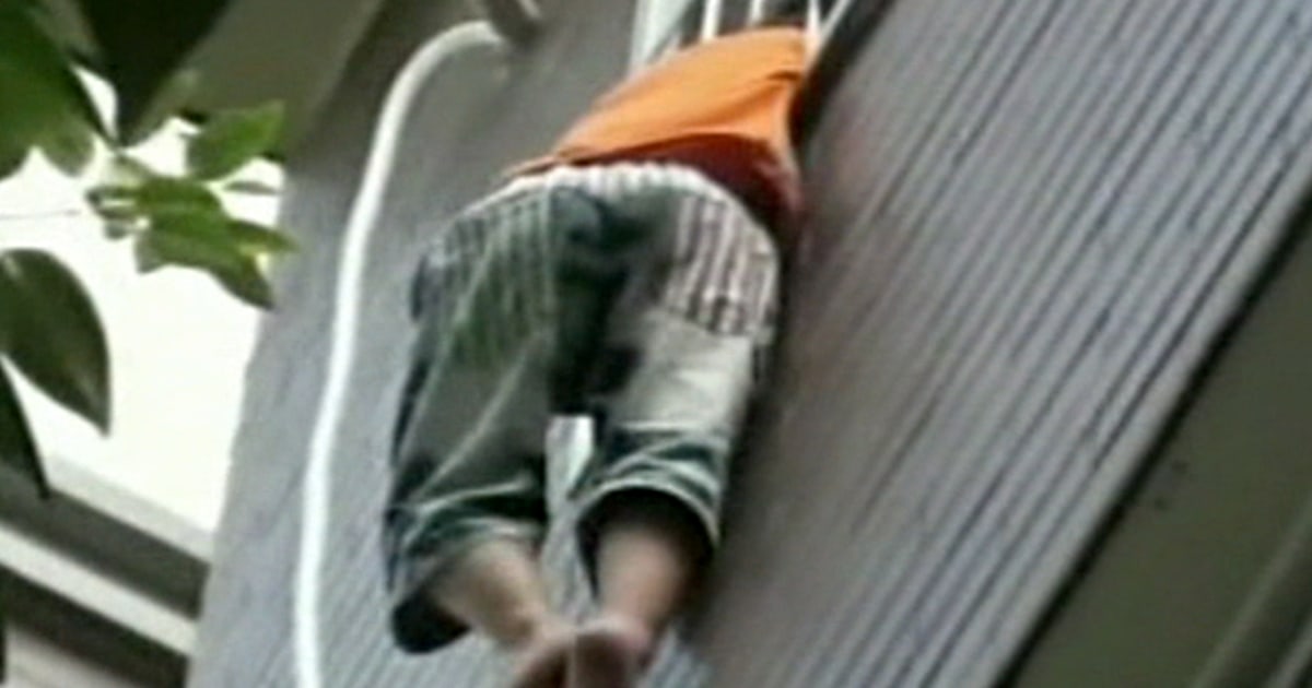 Boy gets head stuck and dangles from building