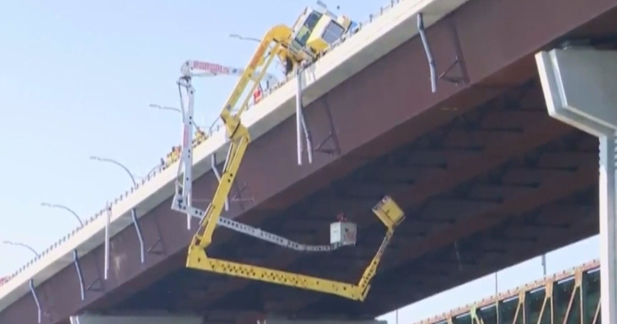 Dangling Crane Leaves Workers Hanging