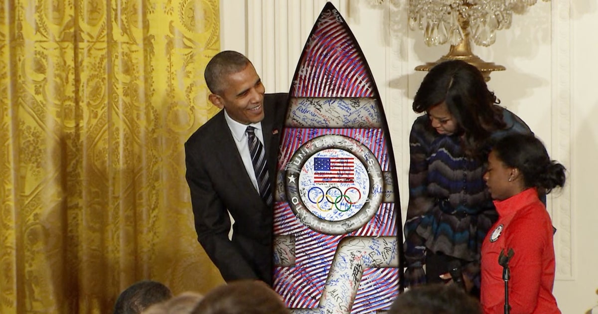 Obamas salute Olympians; Athletes Give President Surf Board