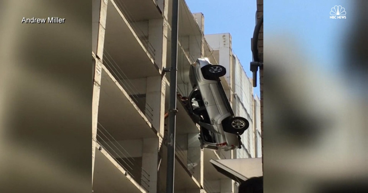 Watch Driver Climb From Dangling Car