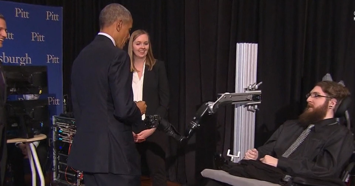 Watch Obama fist bump a robotic arm powered by a brain chip