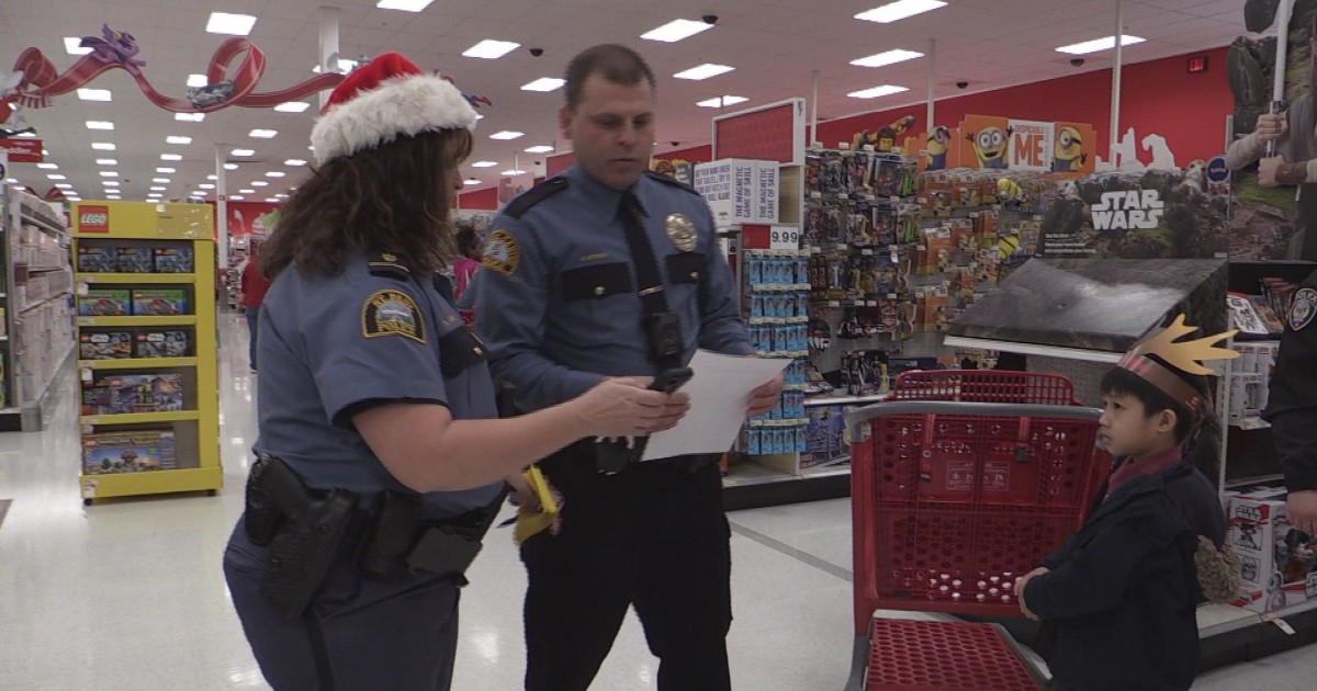 Police officers take kids shopping for the holidays