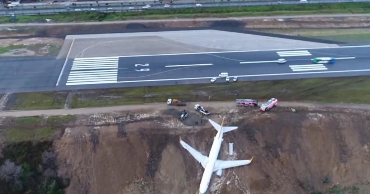 Plane dangles off cliff after skidding off runway in Turkey