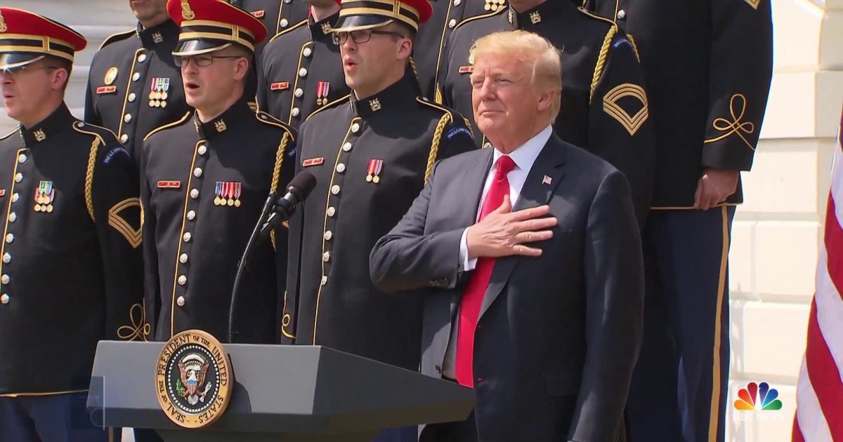 After clawing at Eagles, Trump honors the flag