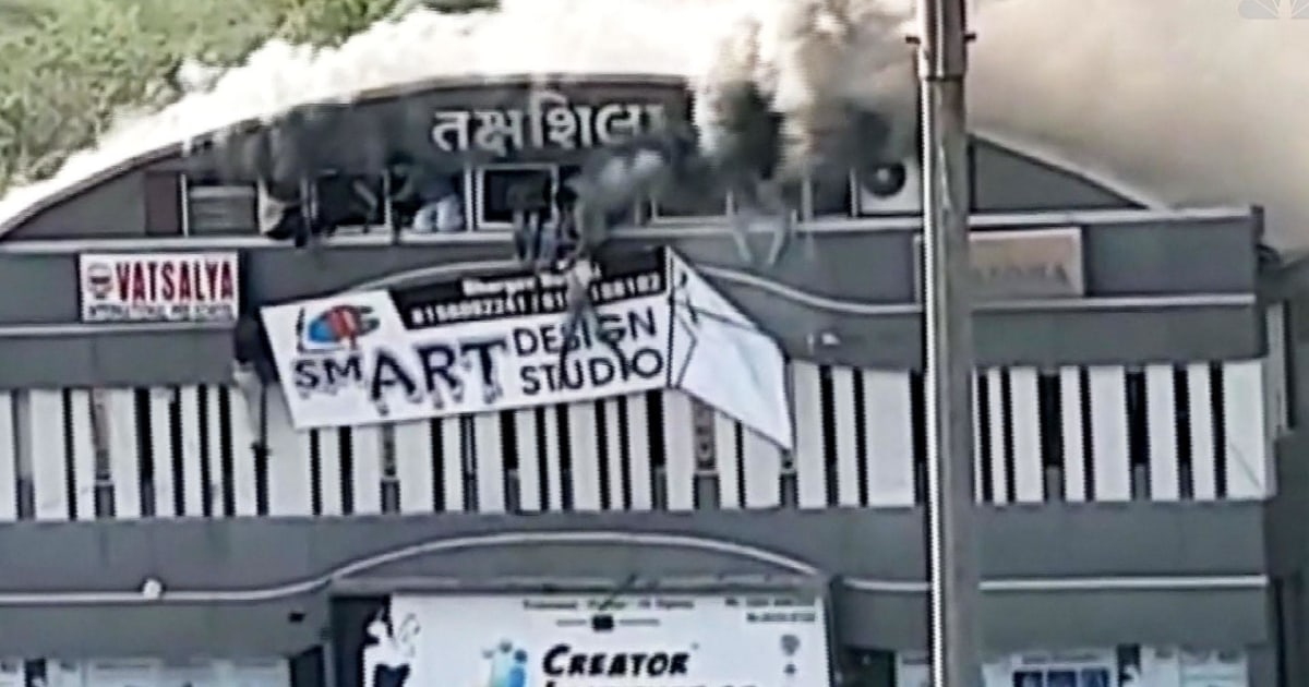 Students plunge from top floor of burning building in Surat, India